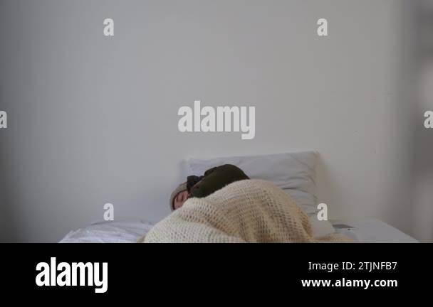 Sleeping woman feeling cold wearing warm winter clothes indoors. broke ...