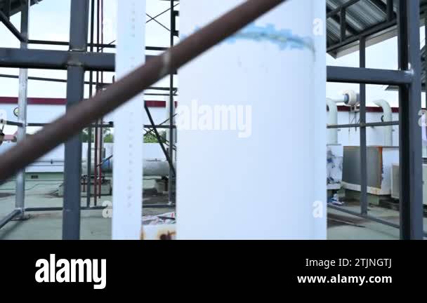 Young engineers working. Plan for construction of a warehouse. See the ...