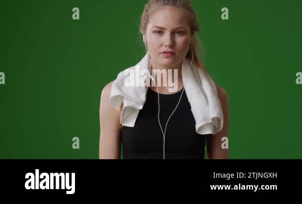 Attractive white girl doing the standing workout on green screen. On ...