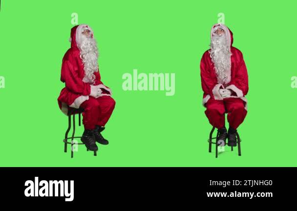 Person dressed like santa on chair posing over full body greenscreen ...