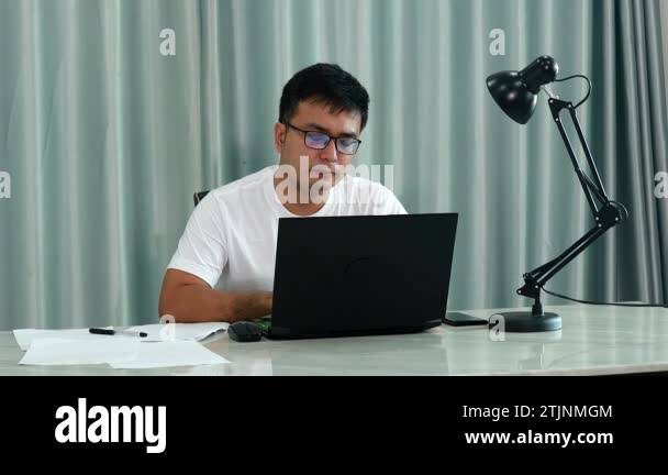 technology, remote job and lifestyle concept - happy asian man man in glasses with laptop ...