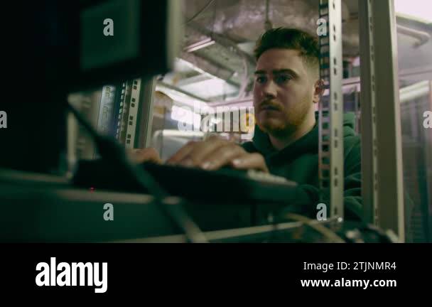 focused hacker data center hacking software system vulnerable cyber security server room ...