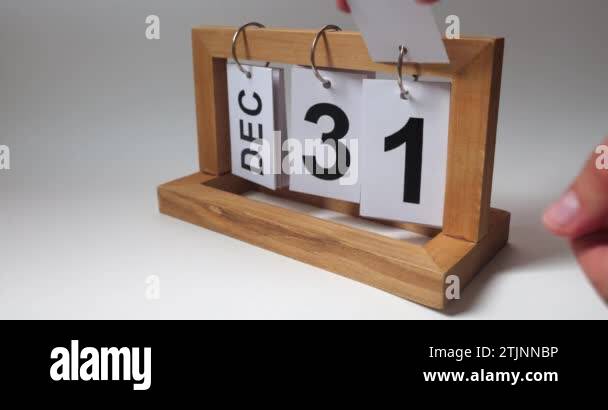 Perpetual calendar with hanging papers with numbers and months, on it ...