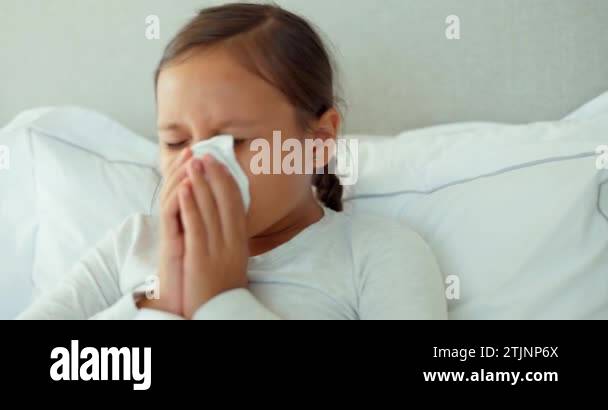 Girl kid, tissue and blowing nose in home for cold, allergies and risk of medical virus. Face ...