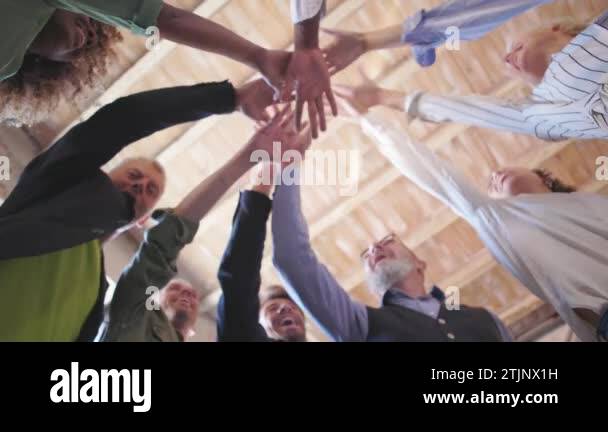 positive teamwork standing hands together - colleagues in teambuilding ...