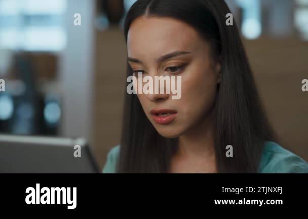 Angry manager scrolling pad nervously alone closeup. Anxious woman solving problems in luxury ...