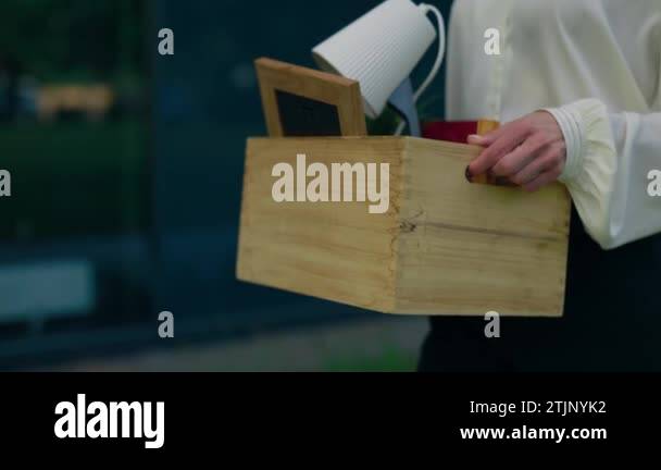 Woman hands holding the box with containing work items. Woman hold box ...