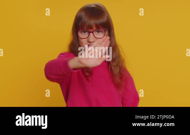 Stop gesture. Angry young preteen child girl kid say No hold palm ...