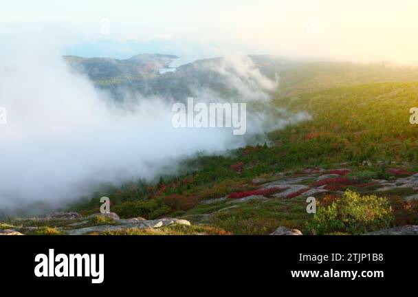 Fog in rising from the sea and the valleys as seen from the top of ...