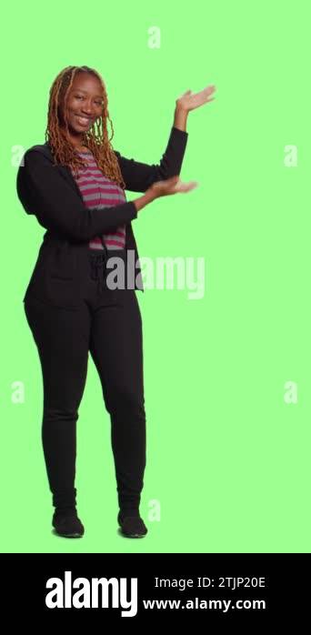 Vertical video: Female model advertising icon over green screen ...