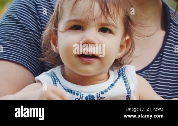 Mother and her baby daughter exploring the outdoors. 4K real life ...