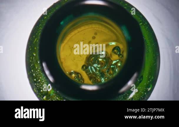 Closeup effervescing beer vessel. Alcoholic liquor bubbling inside ...
