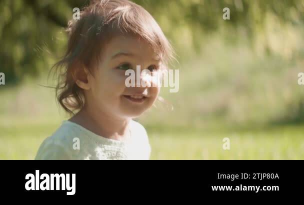 Cute baby girl exploring a park in summer. Real life, candid 4K footage ...