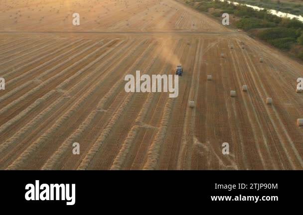 Above tilt view with dolly move upwards, on bales of straw after ...