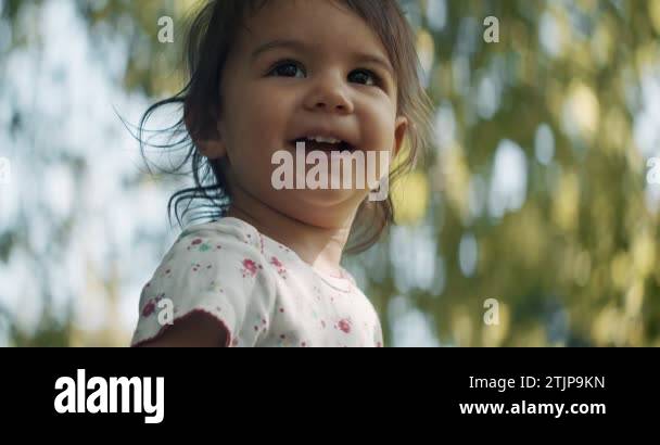 Cute baby girl exploring a park in summer. Real life, candid footage ...