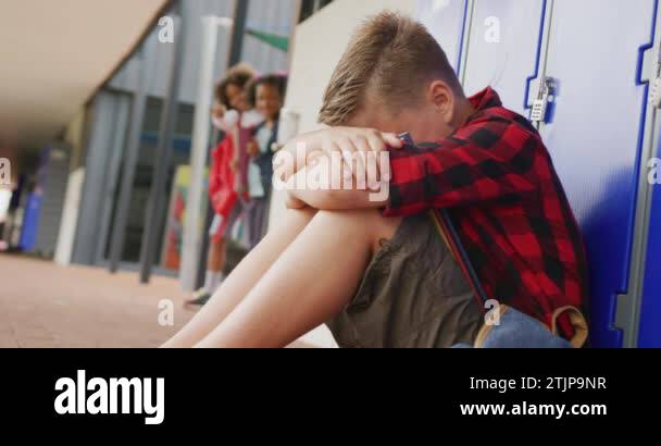 Video of sad caucasian schoolboy being taunted by two diverse children ...