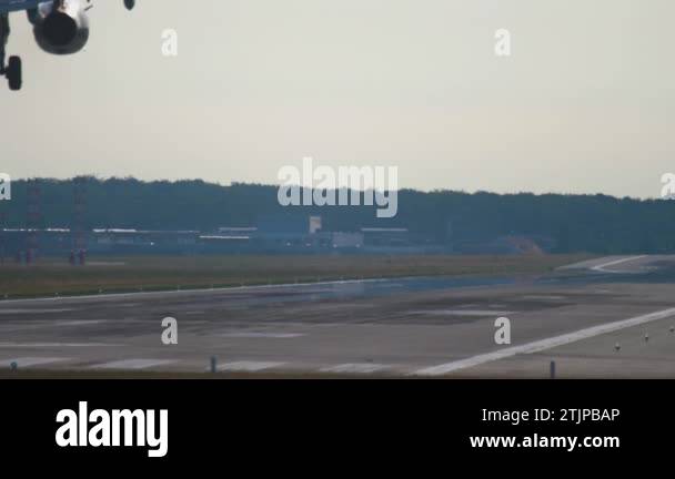 Airliner arriving at the airport. Jet aircraft braking after landing ...
