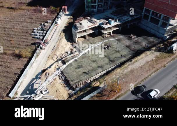 Concreting of reinforced concrete slab. Worker concretes foundation ...