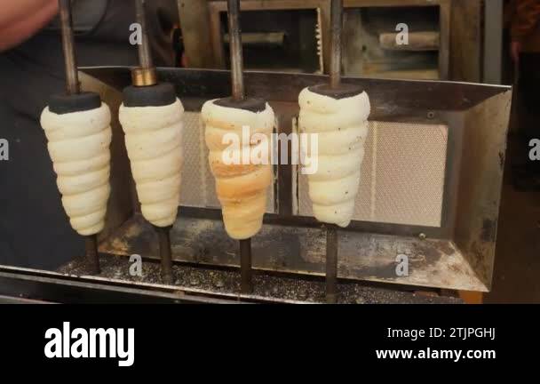 Traditional czech pastry Trdelnik cooking on street market in Prague ...