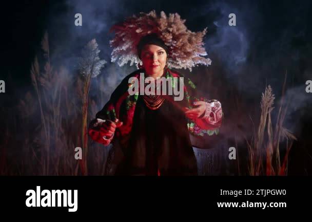 Ukrainian witch - woman in traditional costume with sickle in reeds at ...