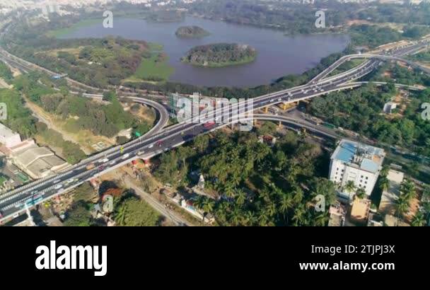 Traffic flow on a regular day over a flyover in bangalore.lake side ...