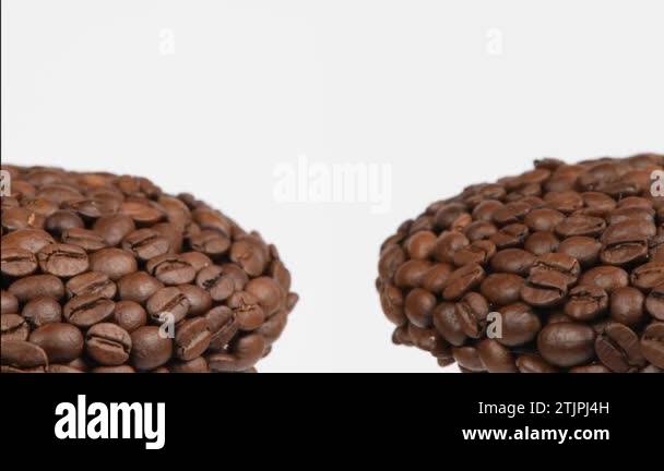 Coffee beans hang in the air on a white background. Free space on top ...