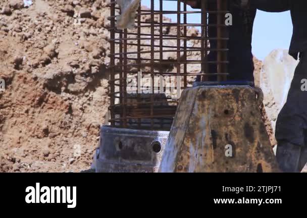 Crane installation of framing rebar at construction site for concrete ...