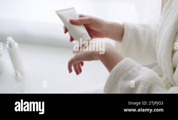 Beautiful woman applying cream on hand skin, slow motion. Female hands ...
