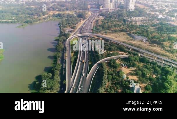 Traffic flow on a regular day over a flyover in bangalore.lake side ...