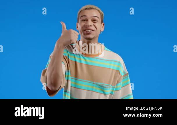 Handsome man makes hand sign like, thumb up gesture. Happy guy, correct ...