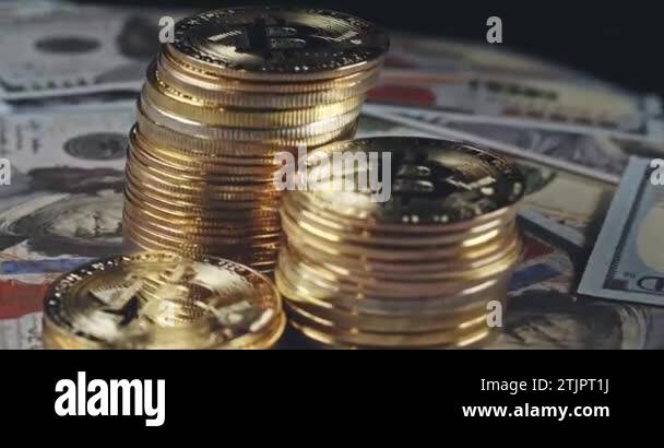 Bitcoin crypto-currency stacked with 100 dollar bills, close up ...