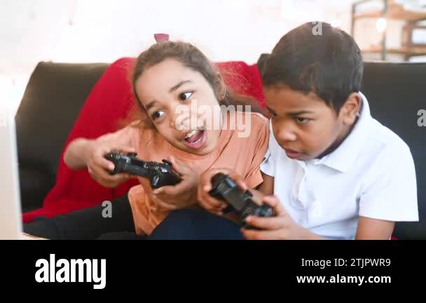 two African American children - a boy and a girl holding a gamepad in ...