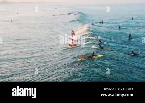Crowd surfing, Bali. People surf the wave on famous Batu Bolong surfing ...