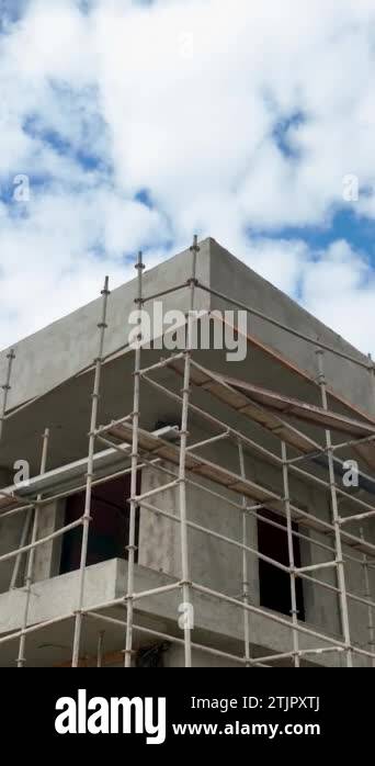 Observe the persistence of builders as they work diligently on the ...