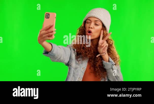 Happy woman, selfie and peace sign for photo on green screen against a studio background. Female ...