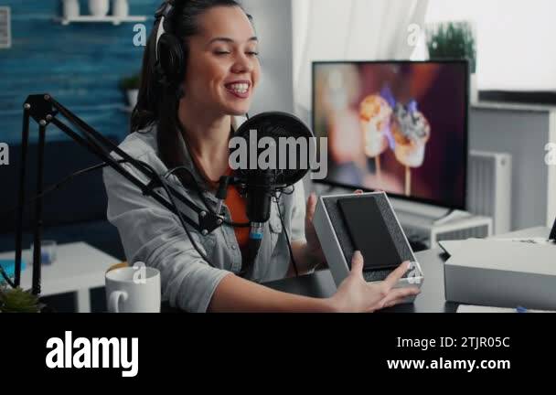 Tech enthusiast doing unboxing review video of modern smartphone while presenting specifications ...