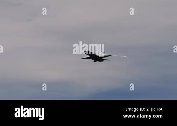 Close-up video tracking of a fighter jet firing cannon and disappearing ...