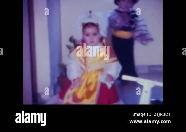 Palermo, Italy February 1970: children playing for carnival disguised as cartoon characters in ...