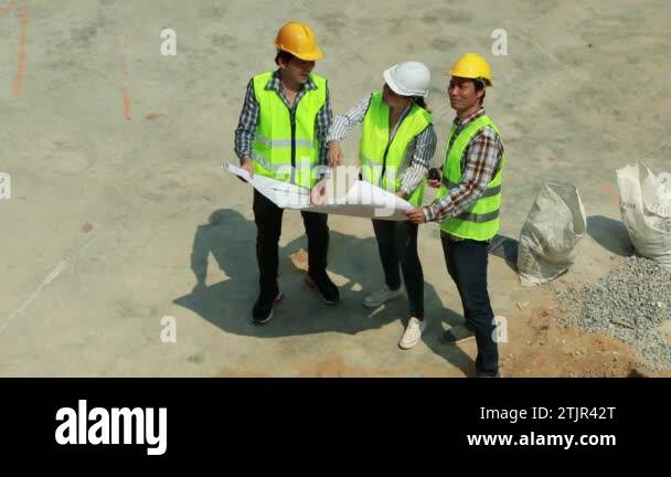 Top view Female lead architect consulted with two male workers standing ...
