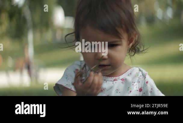 Cute baby girl exploring a park in summer. Real life, candid footage ...
