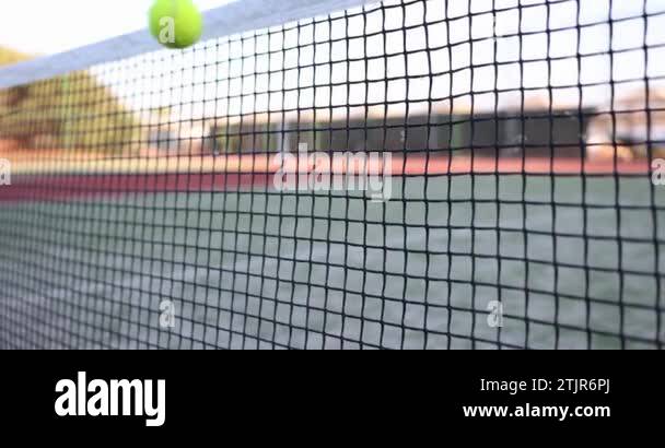Tennis ball hitting to net onblur tennis court. Playing tennis and ...