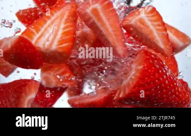 Super Slow Motion Shot of Fresh Strawberries Falling into Water Vortex ...