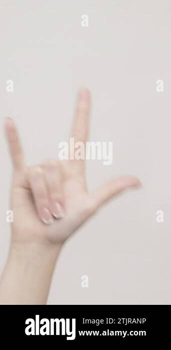 Vertical video. Rock sign. Punk gesture. Woman hand showing horns ...