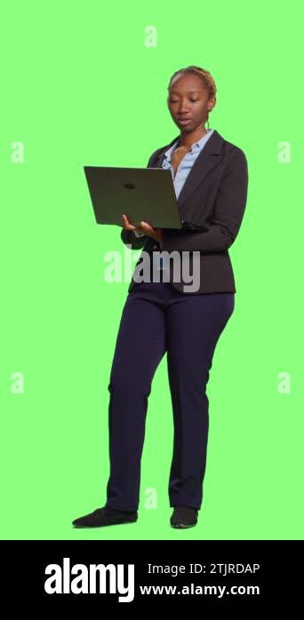 Vertical video: Company employee working on laptop over full body ...