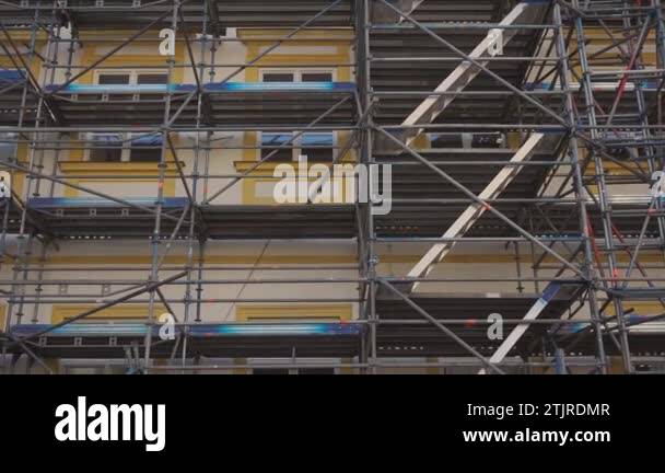 Building renovation. Old building under restoration with system of ...