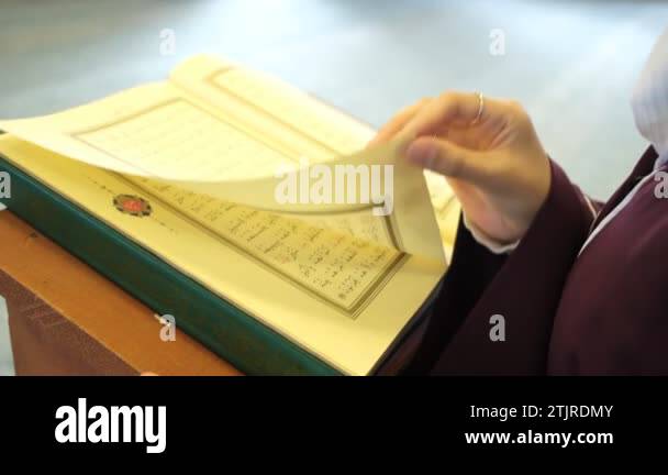Change Page On Quran, finger following the quran sentences, reading ...