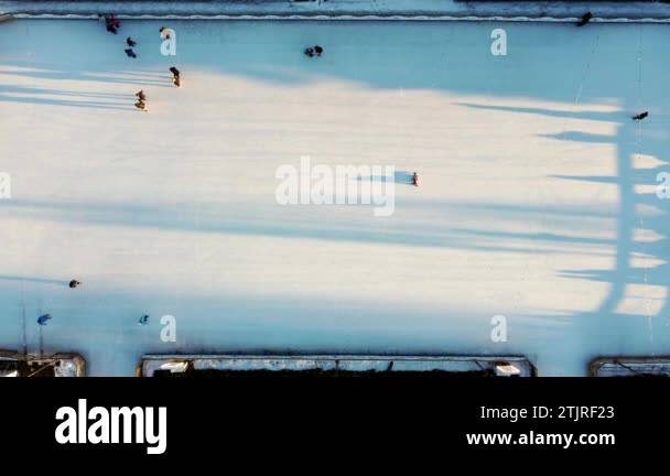People skating on an open-air ice skating rink in the city in the ...