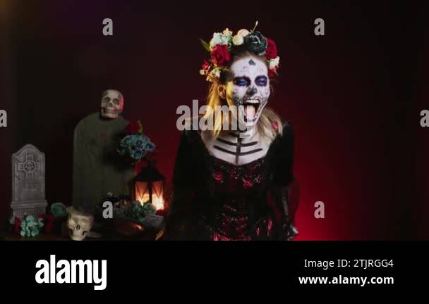 Scary loud goddess of dead yelling in costume with skull body art ...
