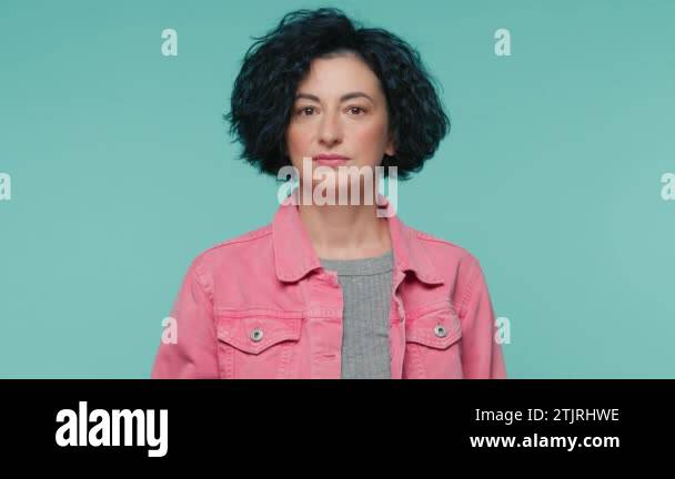 Serious 40s mature woman shakes finger and says no I do not need ...