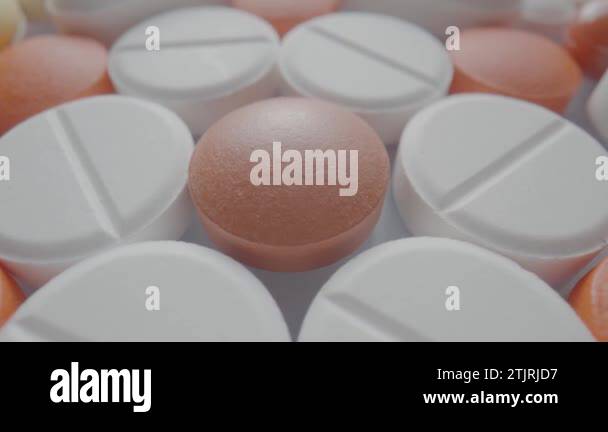 Pattern from medical tablets and pills rotating close up. White and ...